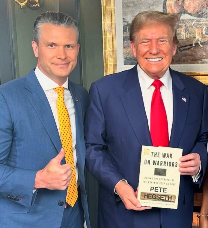 'Fire Hegseth' Protest Sign Confronts Trump on Way to Mar-a-Lago ...